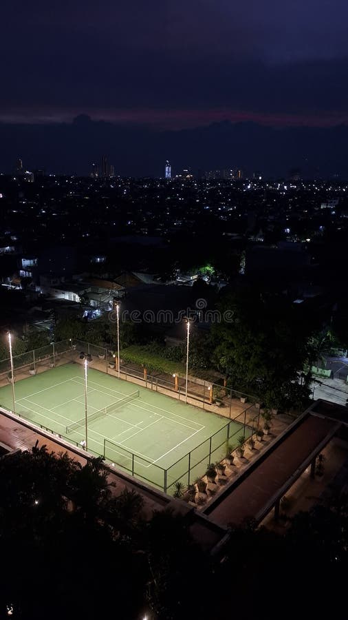 An Overview of Tennis Court Under Night Sky Stock Image - Image of city ...