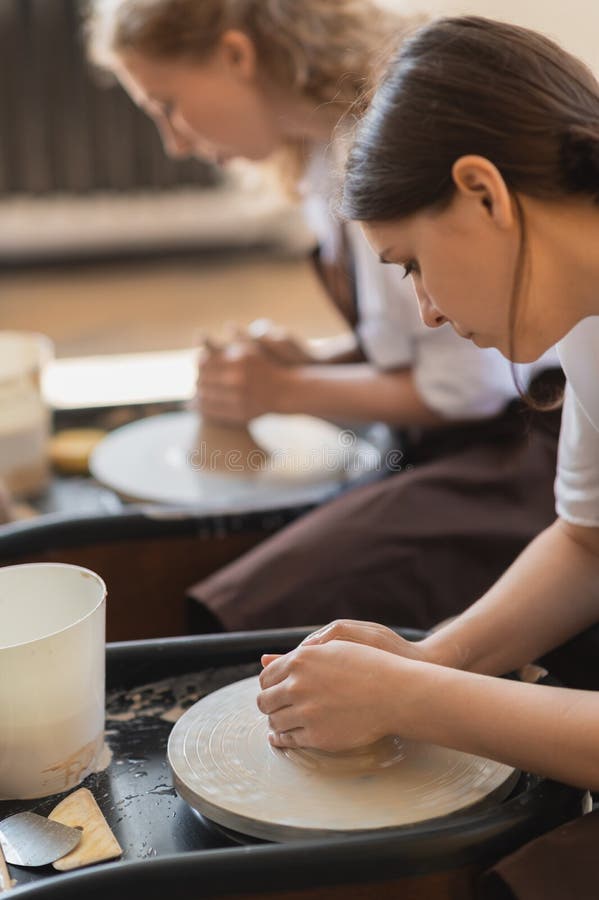 Overview of Two Young Potters by Pottery Wheels while Preparing Ceramic ...