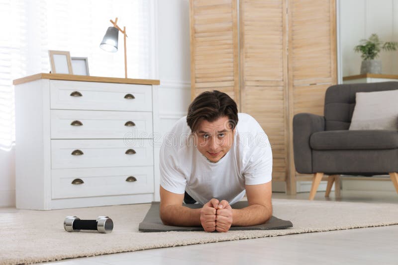 Overweight Man Doing Plank Exercise on Mat at Home Stock Photo - Image ...