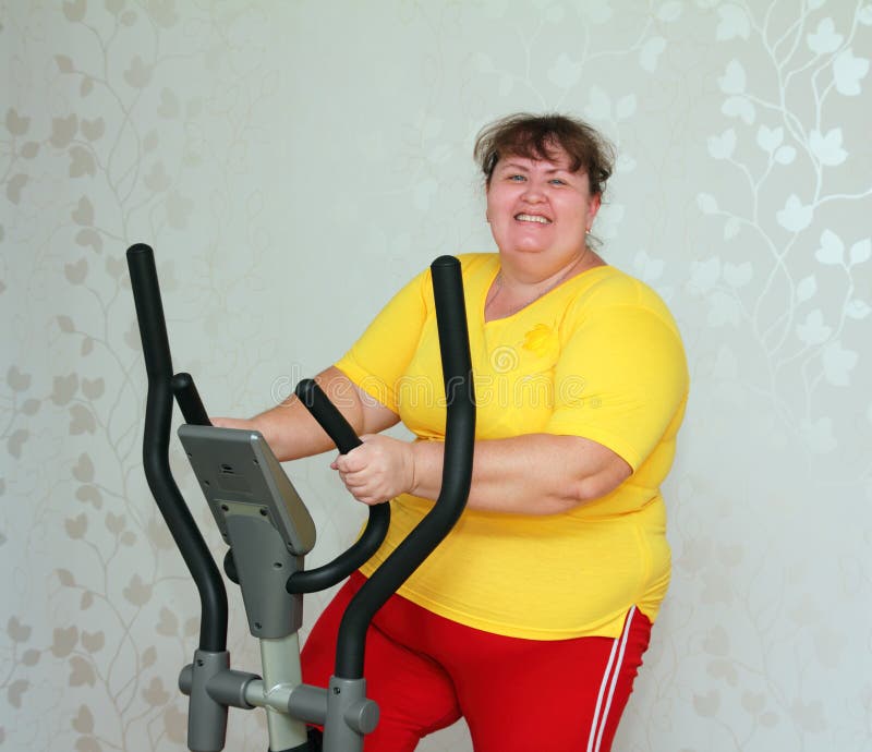 Overweight Woman Exercising on Trainer Stock Photo - Image of health ...