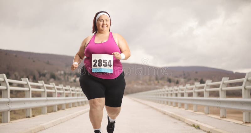 Overweight Woman Running a Race at a Stadium Stock Photo - Image of ...