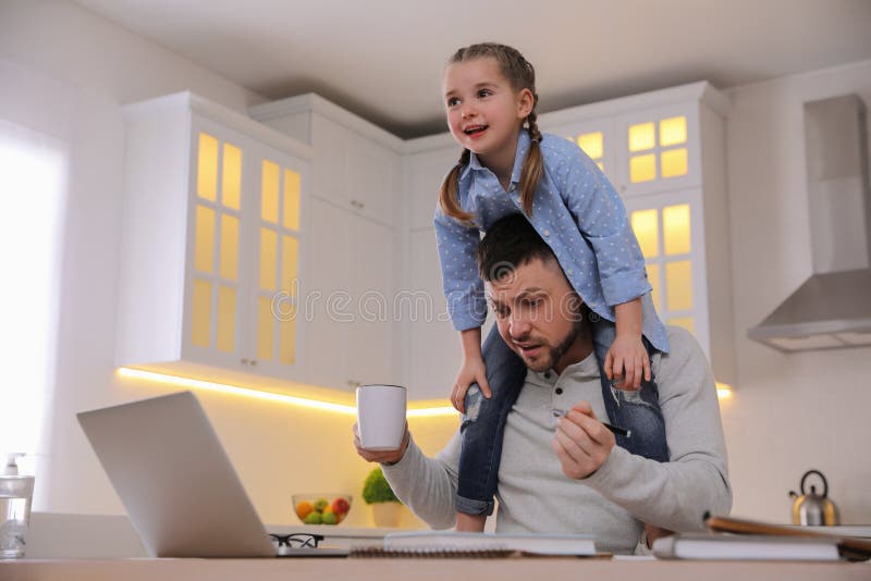 Overwhelmed Man Combining Parenting and Work at Home Stock Image ...