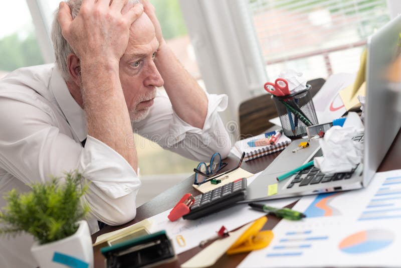 Overworked Businessman Sitting at a Messy Desk Stock Photo - Image of ...