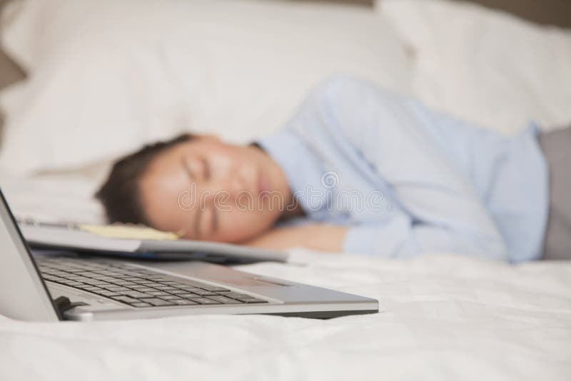 Overworked Businesswoman Sleeping in the Bed with Her Laptop Open Stock ...