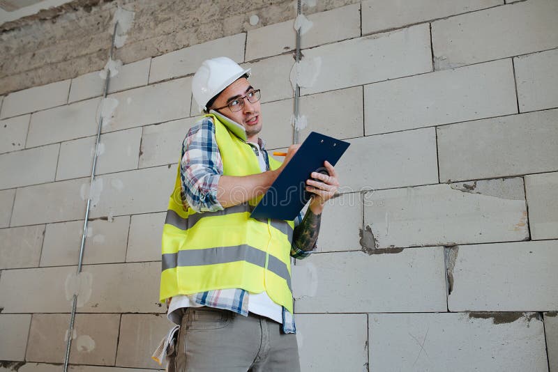 Overworked Construction Engineer Discussing Problems on the Phone ...