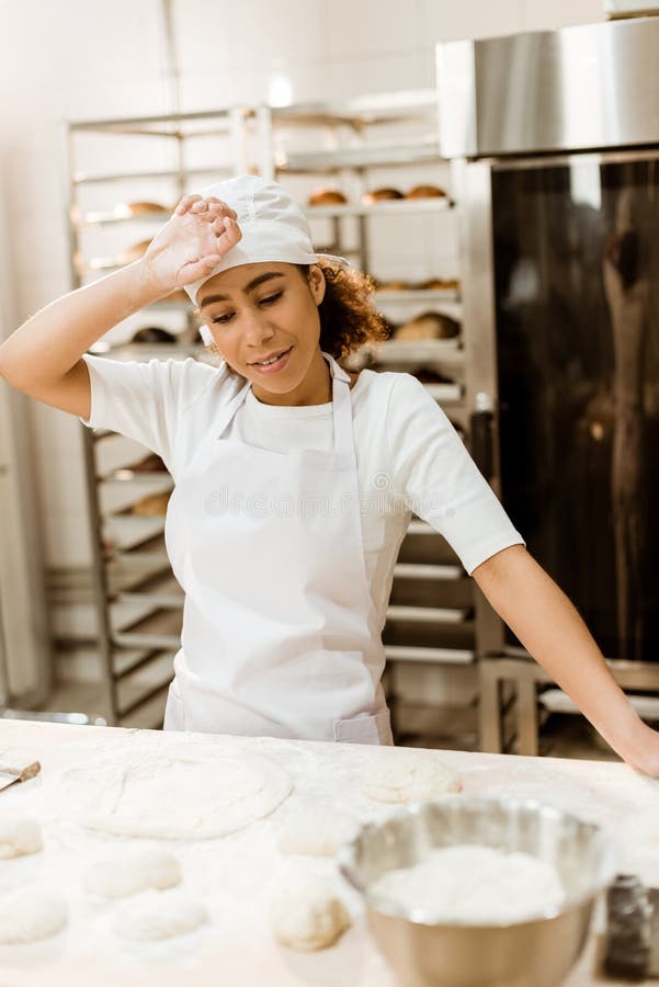 Overworked Female Baker Wiping Sweat from Forehead Stock Photo - Image ...