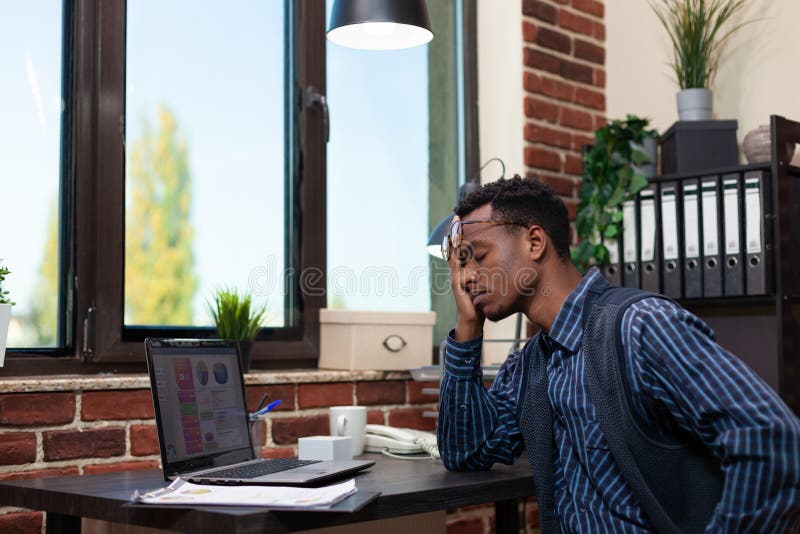 Overworked Startup Worker Falling Asleep at Desk in Red Brick Office ...