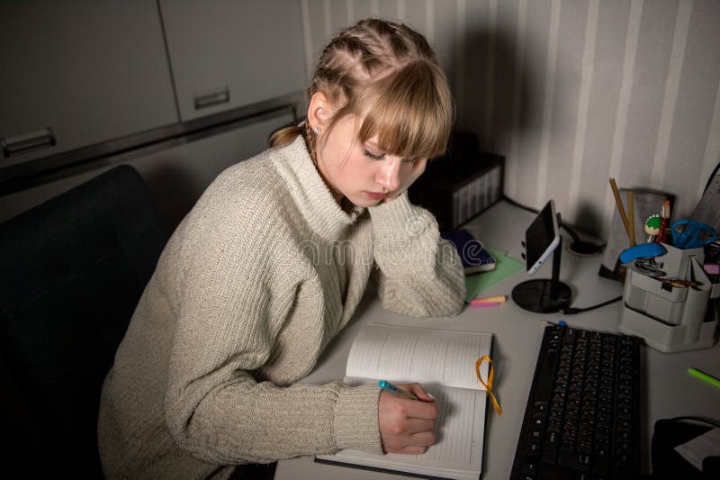 An Overworked Student Sits at the Computer at Night. Make Notes in a ...