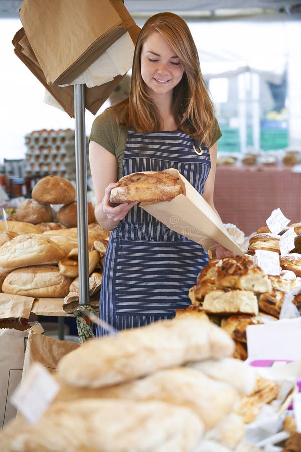 Bread Stall Owner at Market Serving Customer with Loaf Stock Image ...