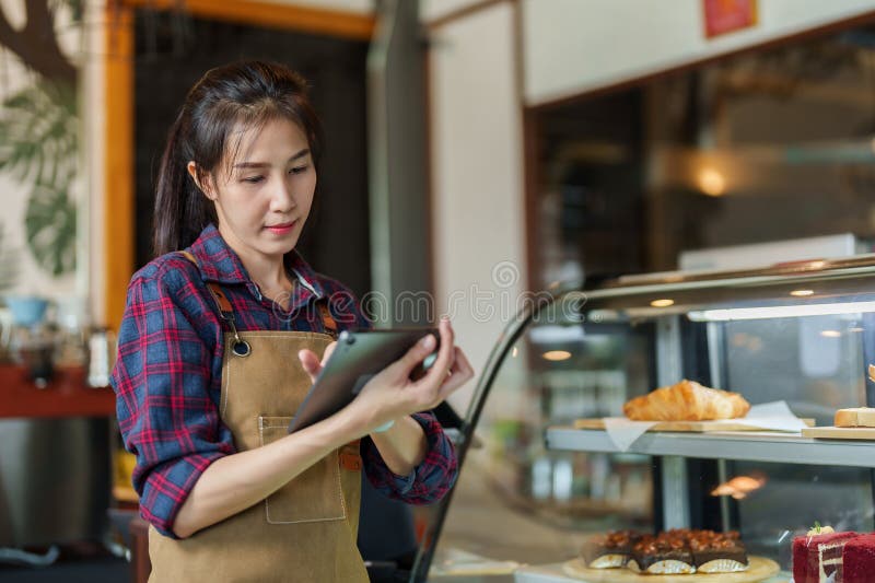 The Owner is Checking Out the Bakery. a Tablet in Hand Check Orders ...