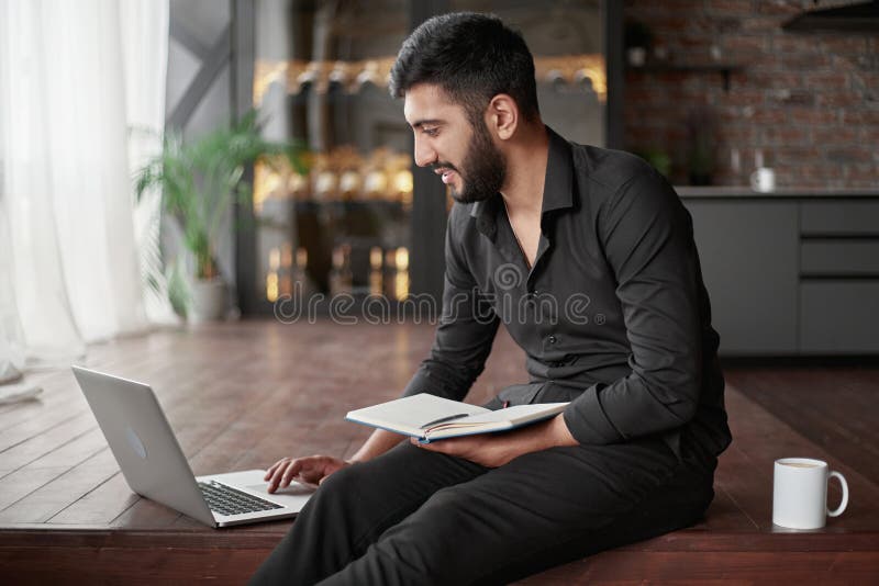 Owner of a New Business is Taking Notes in a Notebook while Sitting on ...