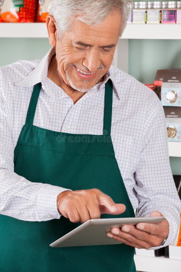 Owner Using Digital Tablet in Grocery Store Stock Photo - Image of ...