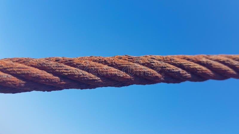 Oxidized Interlocked Wire Loop Cables in the Foreground with Sky and ...