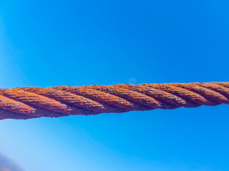 Oxidized Interlocked Wire Loop Cables in the Foreground with Sky and ...