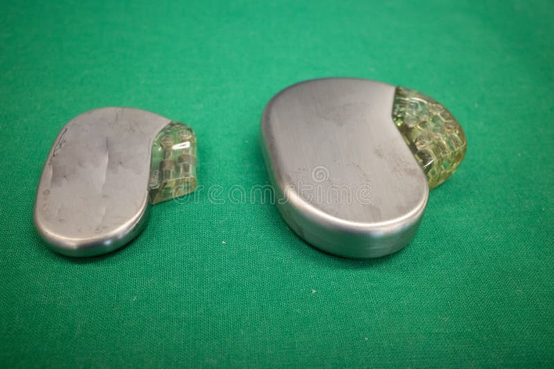 Pacemaker Lies Directly Next To a Defibrillator on a Green Surgical ...