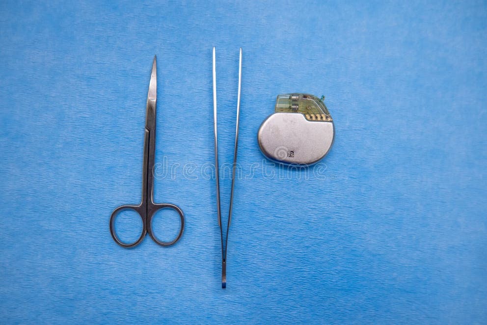 Pacemaker, Scissors and Tweezers on a Blue Surgical Pad Stock Image ...