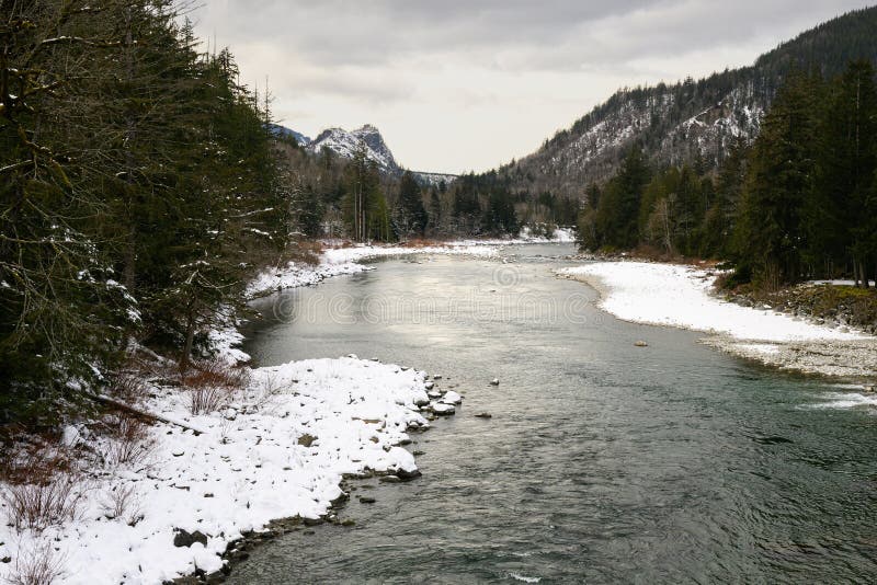 Pacific Northwest River Flowing between Snow Covered Beaches in Winter ...