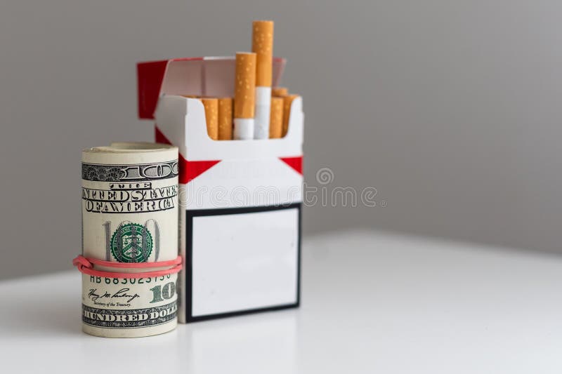 Pack of Cigarettes on a Photo of Hundred-dollar Notes. Concept of High ...