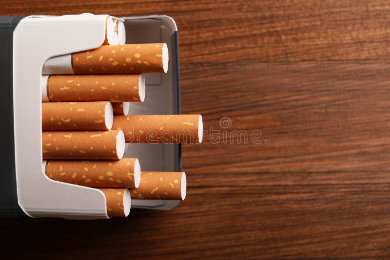 Pack of Cigarettes on Wooden Table, Above View. Space for Text Stock ...