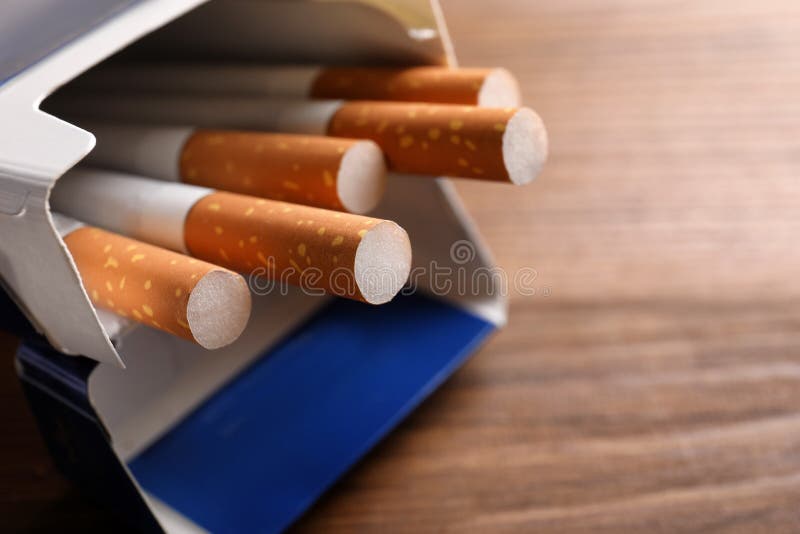 Pack of Cigarettes on Wooden Table, Closeup Stock Image - Image of ...