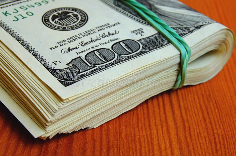 Pack of Hundred-dollar Bills Folded in Two, Stretched by a Rubber Band ...