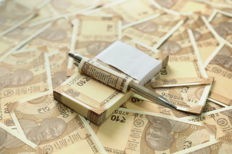 Pack of Indian 10 Rupee Currency Note with Pen and Scattered Indian ...