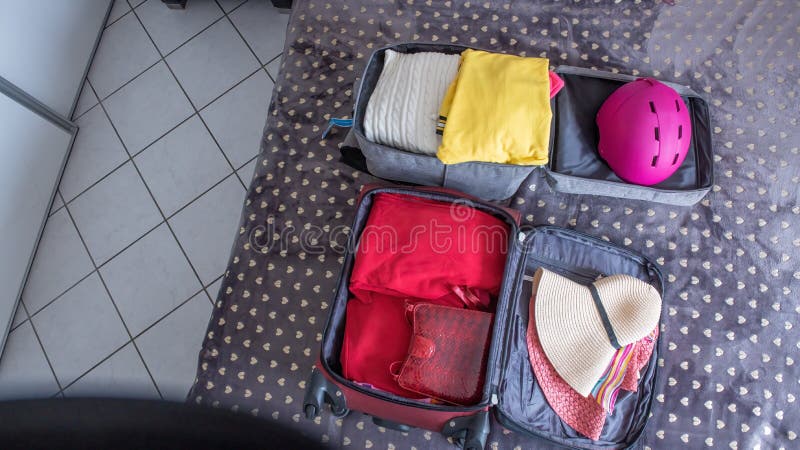 Pack Your Vacation Suitcase on the Bed with Clothes and Hats. Packing ...