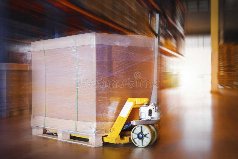 Package Boxes with Hand Pallet Truck in Blurred Warehouse Space ...