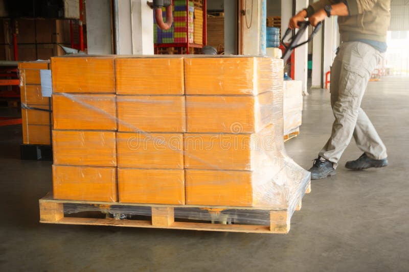 Package Boxes Wrapped Plastic on Pallet. Workers Unloading Package ...
