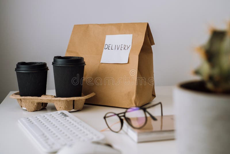 Package Marked Delivery and Cups of Coffee at Workplace, Glasses and ...