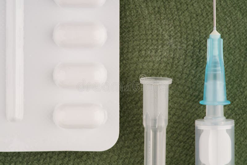 A Package of Pills and a Syringe with an Open Needle is Lying Next To ...