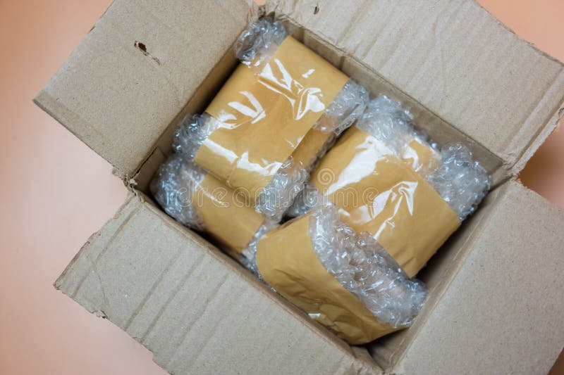 Package Wrapped in White Bubble Wrap and Adhesive Tape in Brown Box ...