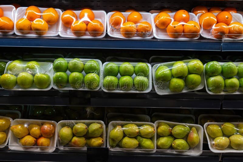 Packaged Apples, Pears and Oranges on the Supermarket Shelf Stock Photo ...