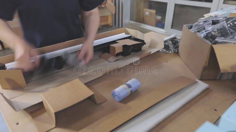 Packaging of Finished Goods in a Box. Workers Pack Finished Products ...