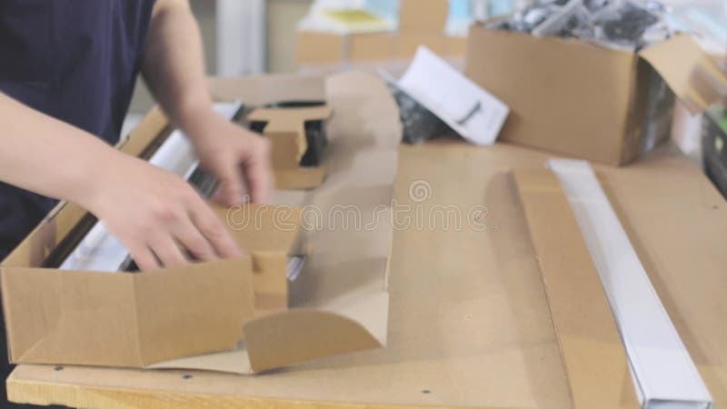 Packaging of Finished Goods in a Box Timelapse. Workers Pack Finished ...