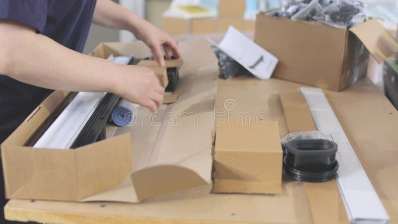Packaging of Finished Goods in a Box. Workers Pack Finished Products ...