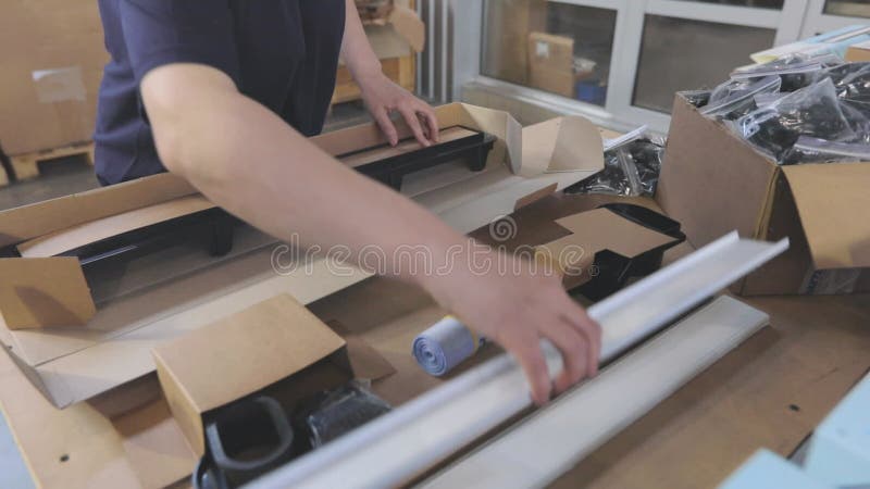 Packaging of Finished Goods in a Box. Workers Pack Finished Products ...