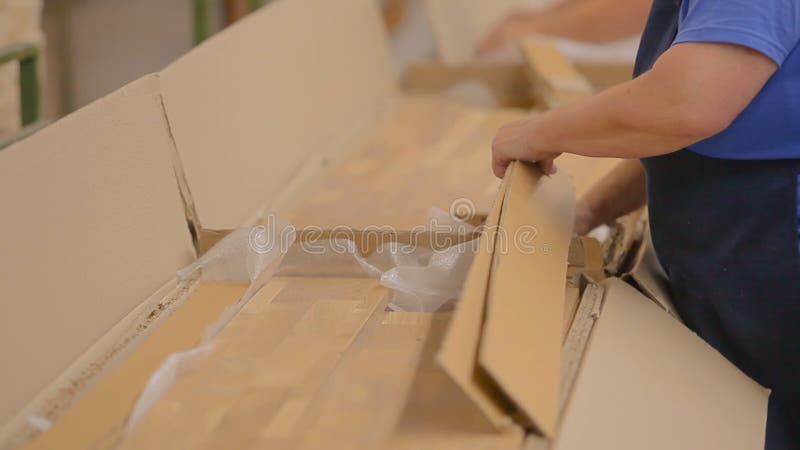 Packaging of Finished Goods in a Box. Workers Pack Finished Products ...
