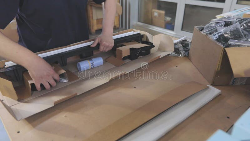 Workers Pack Finished Products into a Box. Packaging of Finished Goods ...