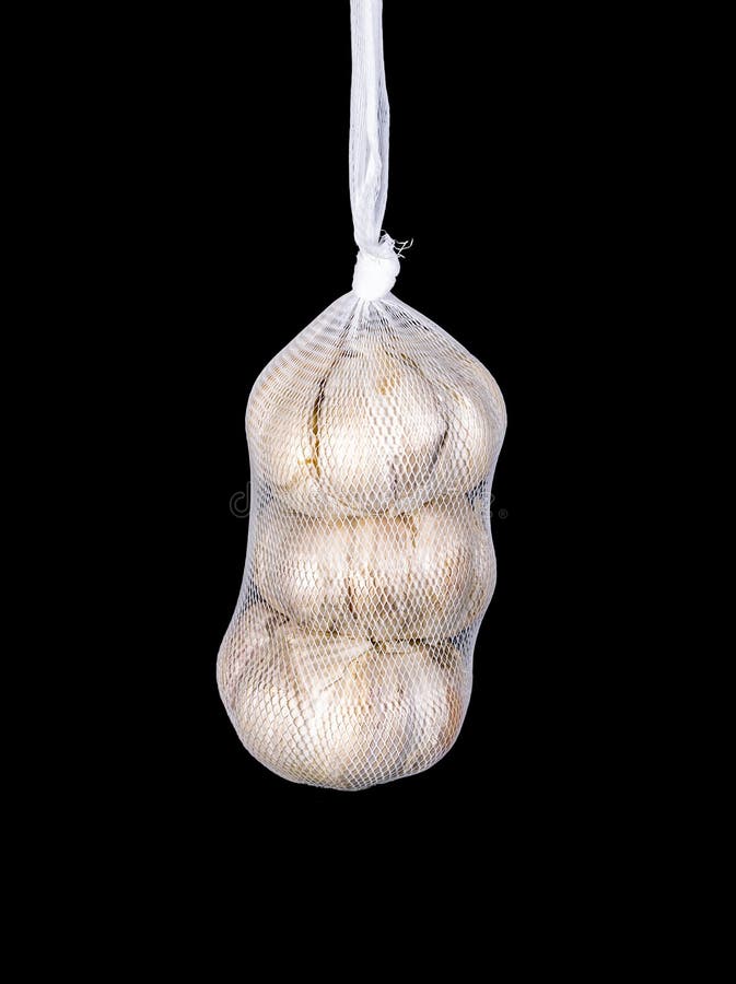 Packed Garlic in a Net Isolated on a Black Background Stock Photo ...