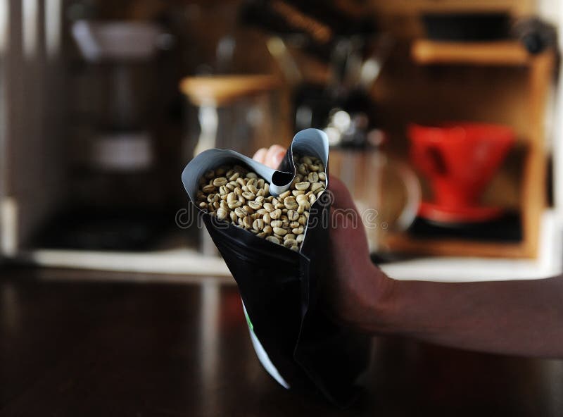 Packet of Green Coffee is Compressed in Shape of Heart in Hands. on the ...