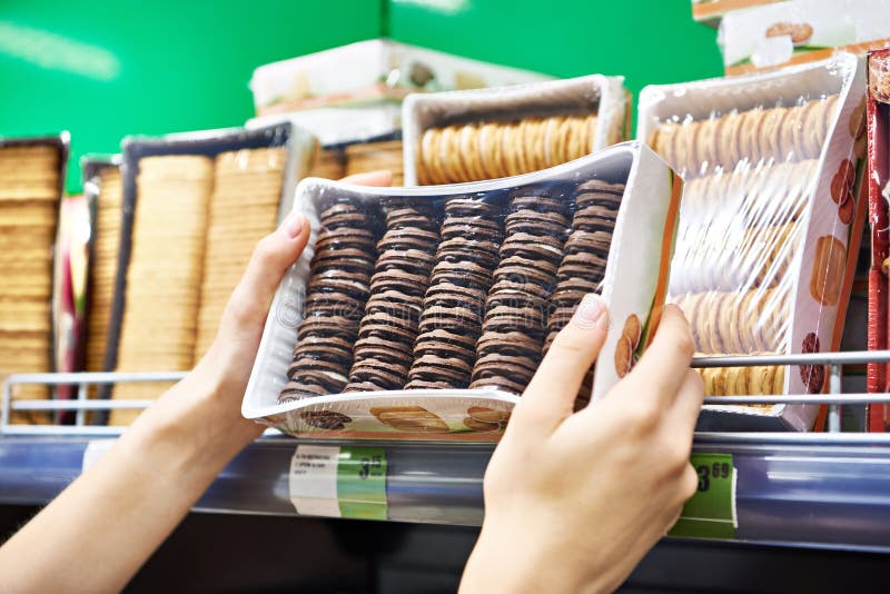 Packets of Chocolate Cookies in Hands of Buyer Stock Photo - Image of ...