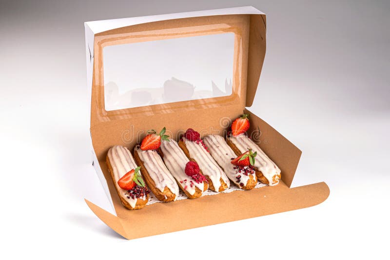 Packing Box with Eclair with Glaze and Strawberries, Isolated on White ...
