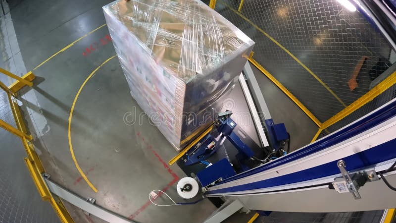 Packing Boxes in Plastic Film. Box Stretch Wrapping Machine. Pallet ...