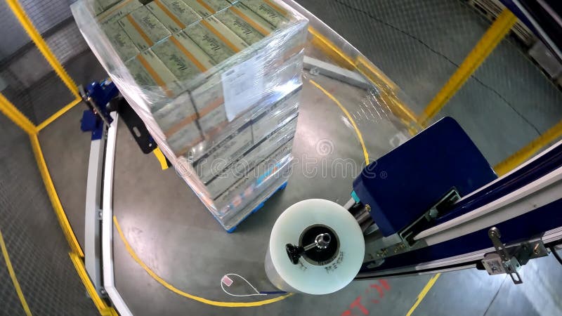 Pallet Wrapping Machine. Packing Boxes in Plastic Film. Box Stretch ...