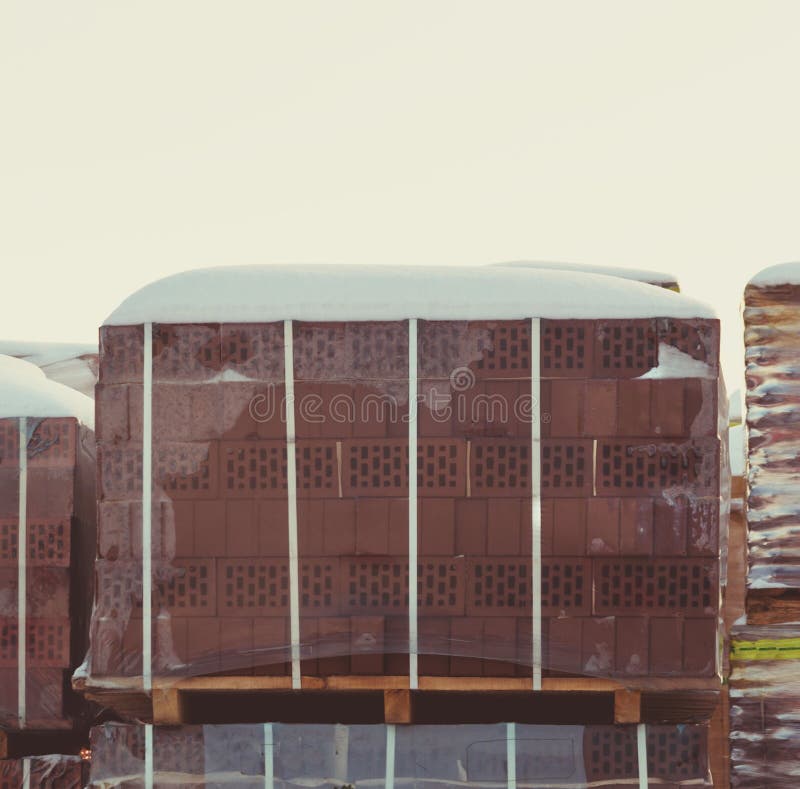 Packing of Bricks of Under a Polyethylene Film on the Pallet. Stock ...
