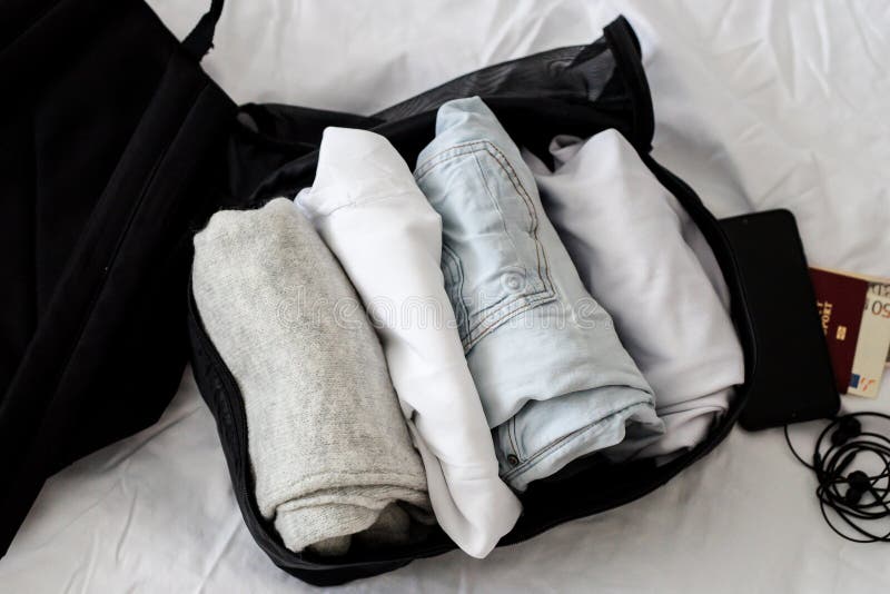 Packing Clothes, Documents into the Suitcase. Travel Concept, Packing ...