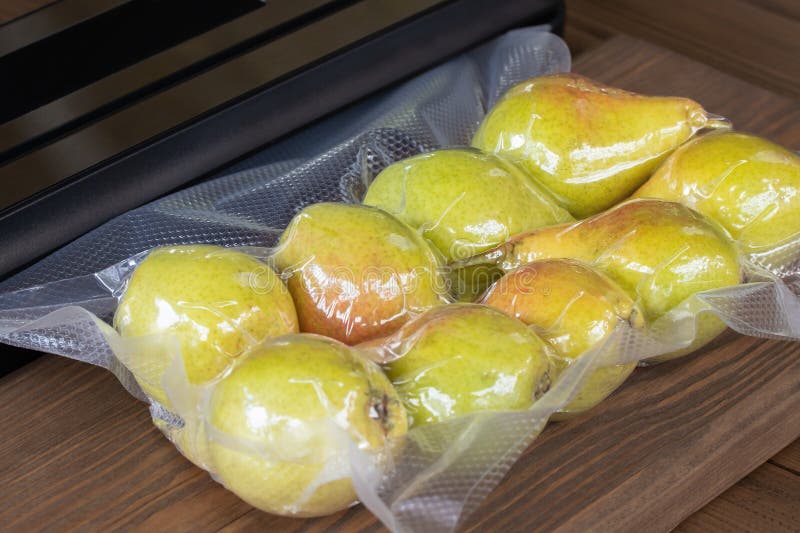 Packing Fresh Pears with a Vacuum Packer for Long-term Storage Stock ...