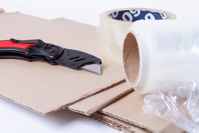 Packing the Goods in a Cardboard Box and Stretch Film. Tools for ...
