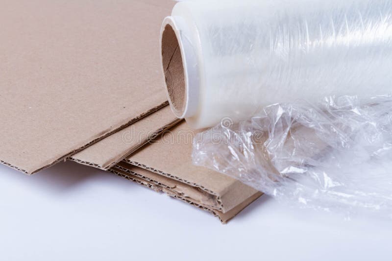 Packing the Goods in a Cardboard Box and Stretch Film. Tools for ...